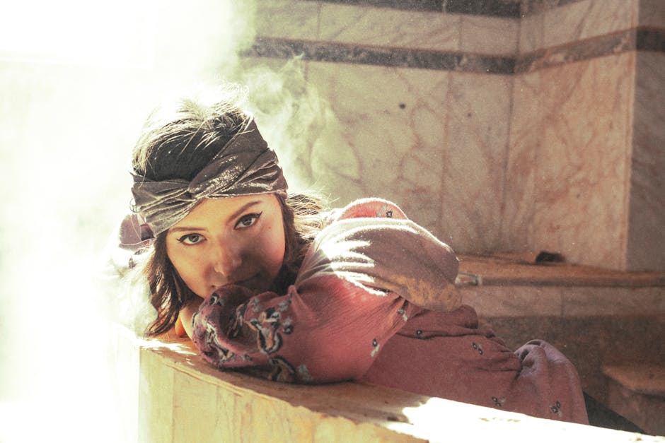 A woman relaxes in a hammam bathed in ethereal light