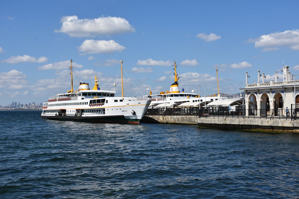 Ferries docked at a pier in Istanbul under clear blue sky