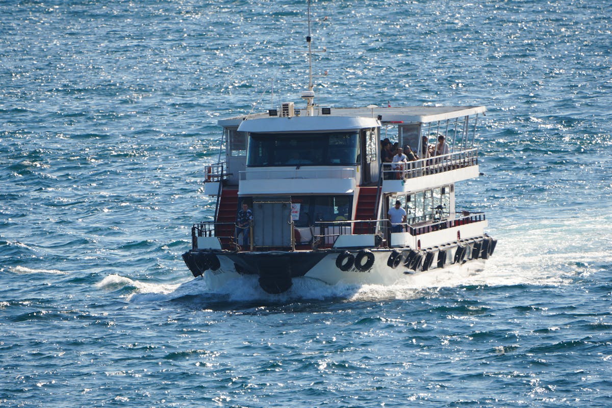 Passenger ferry traveling on the Bosphorus Strait in Istanbul under clear skies