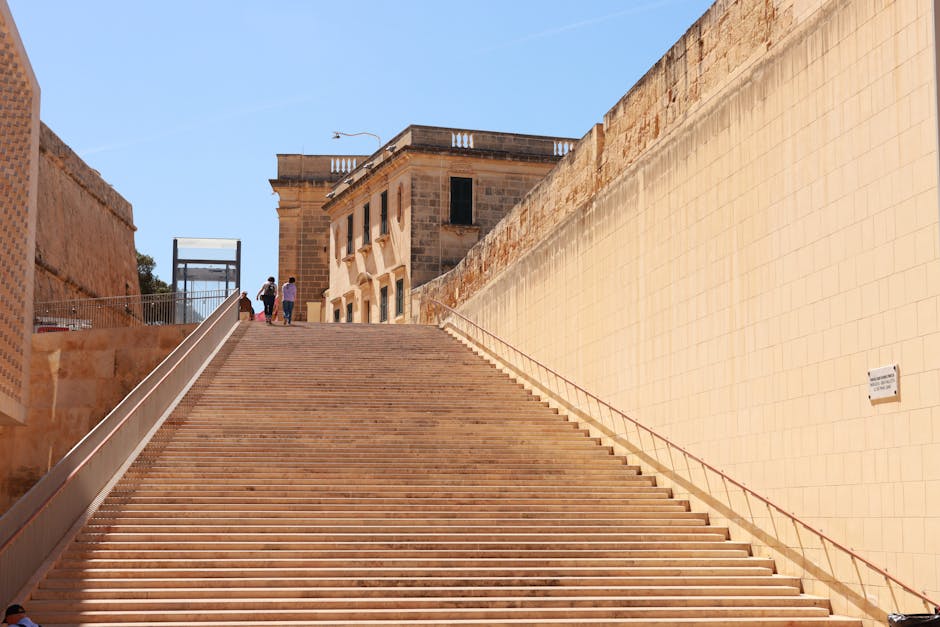 Stone steps ascending to historic buildings in Valletta, Malta on a sunny day