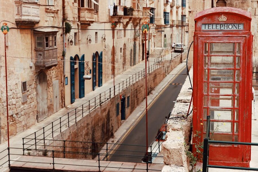 Charming street view in Valletta Malta with a classic red telephone booth