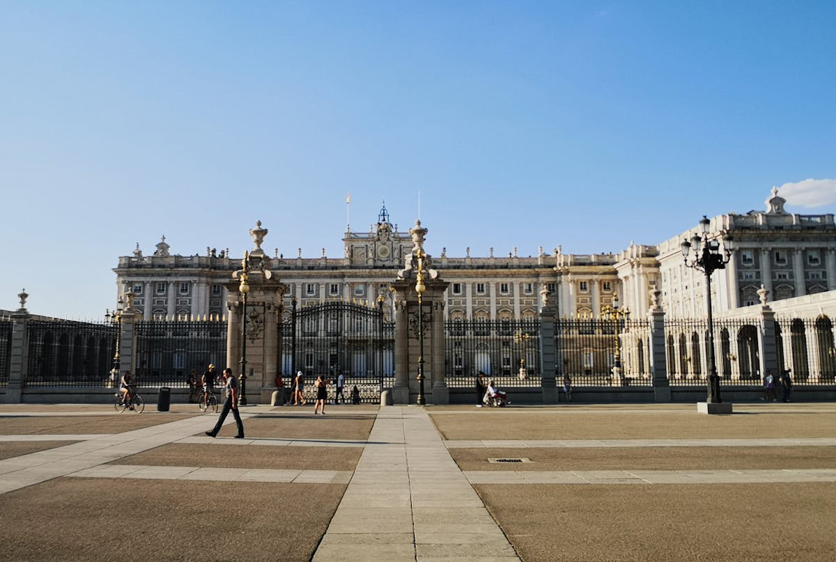 Royal Palace of Madrid with people walking