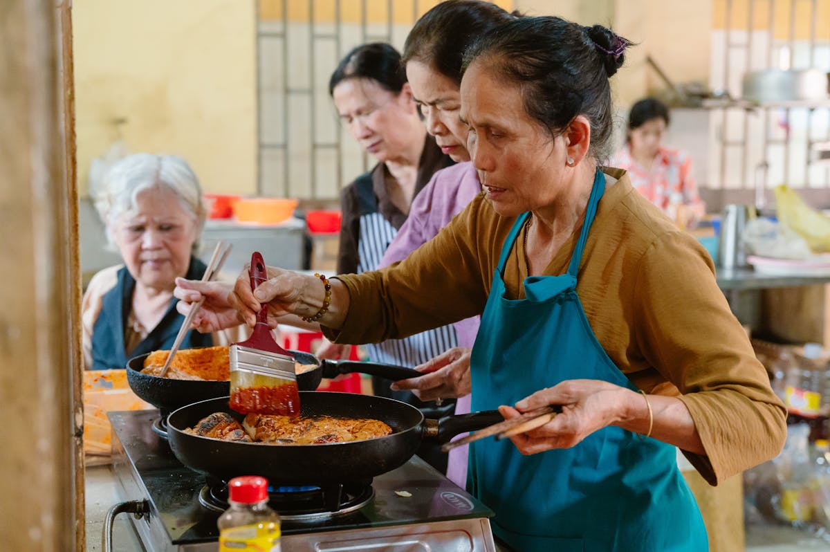 Group of women cooking together in a kitchen