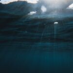 Sunlight rays penetrating deep blue ocean water