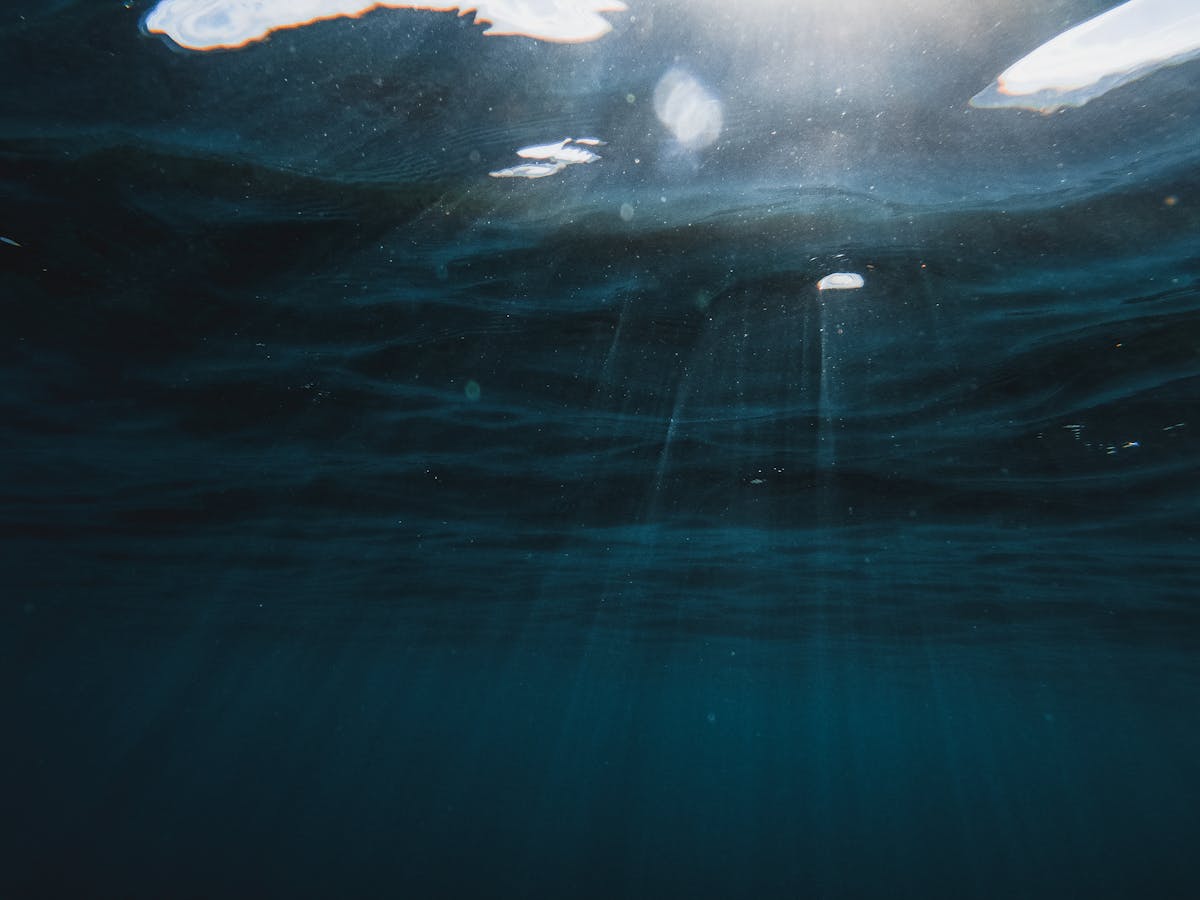 Sunlight rays penetrating deep blue ocean water