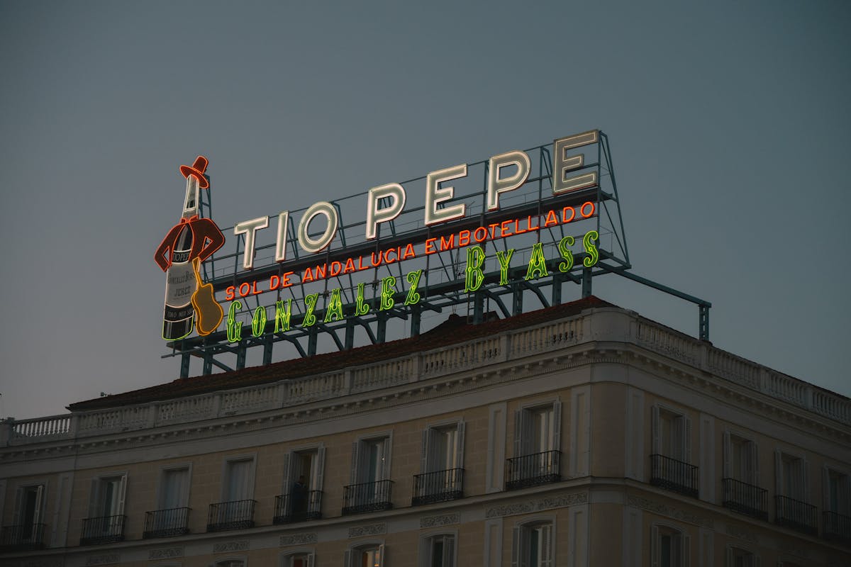 Neon Tio Pepe sign at Puerta del Sol Madrid at dusk