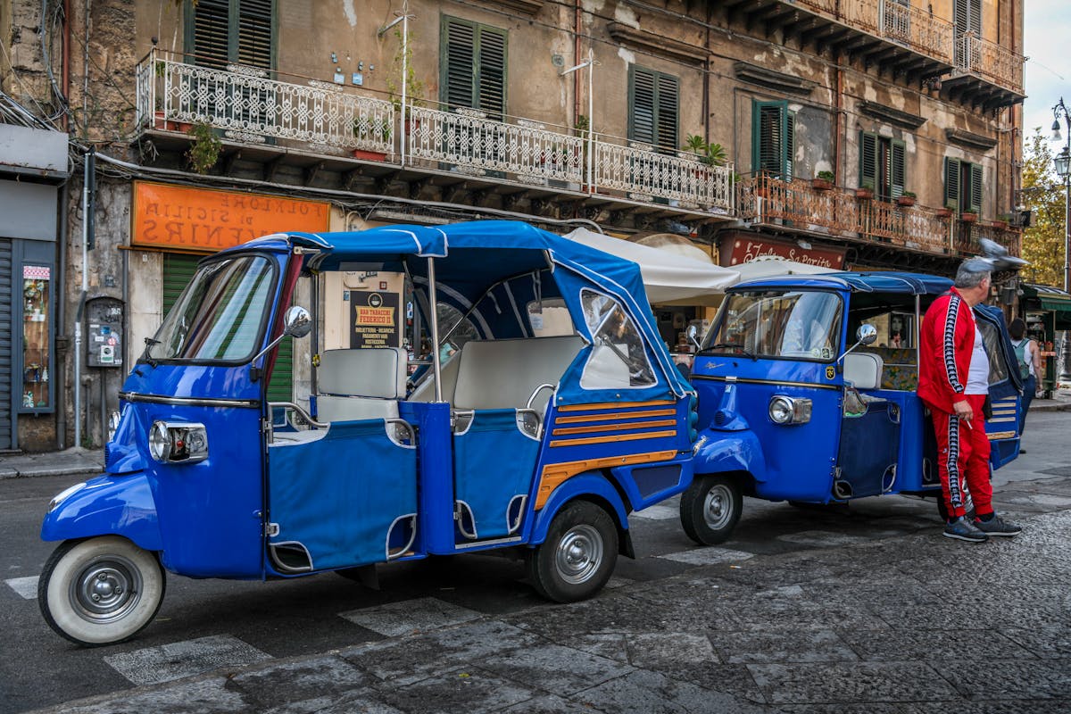 Blue tuk tuks parked in a charming European street