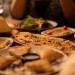 Close-up of traditional Turkish dishes including hummus flatbread and pastries