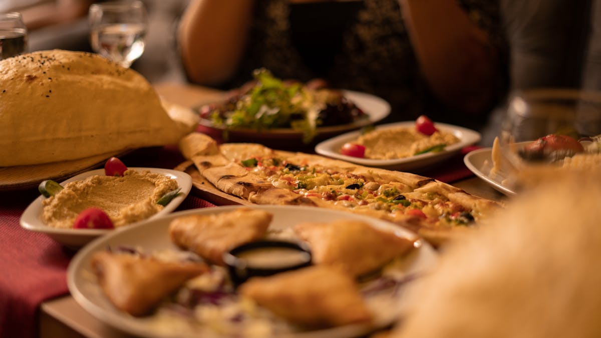 Close-up of traditional Turkish dishes including hummus flatbread and pastries