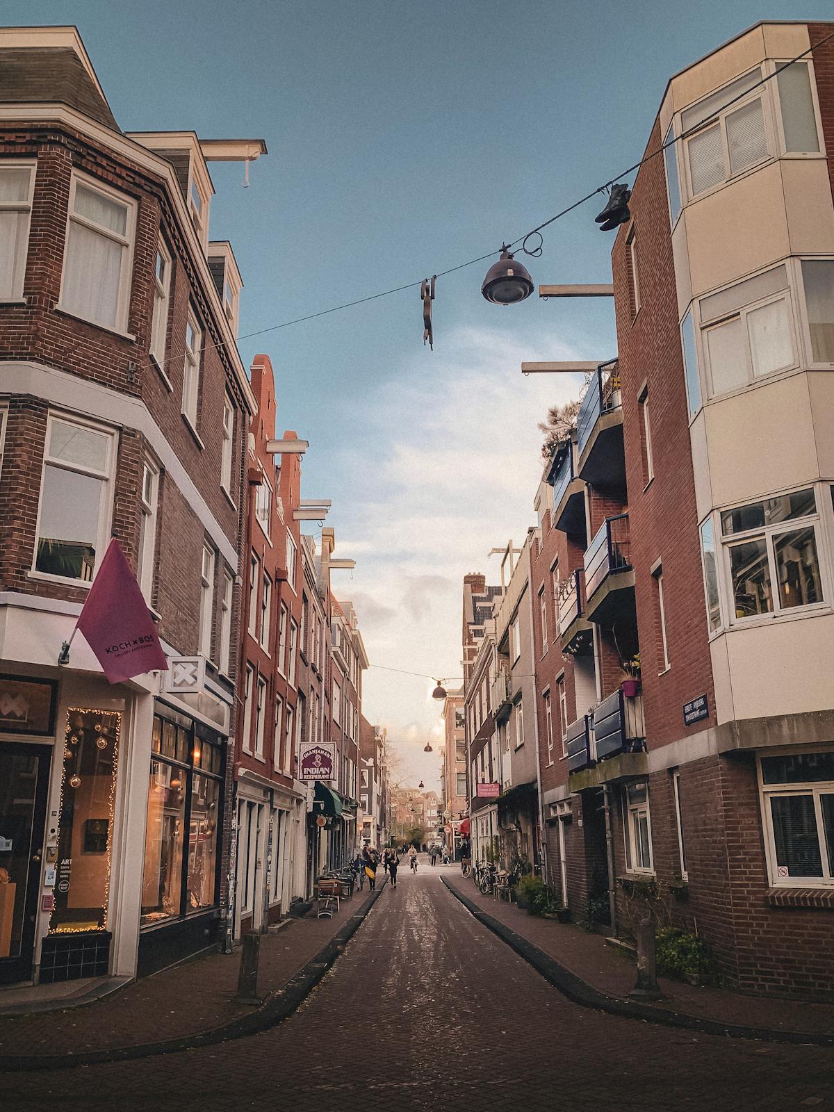 Amsterdam street showcasing Dutch architecture with parked bicycles