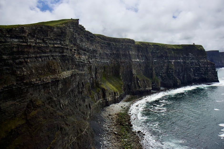 Rugged Atlantic cliffs of Ireland with sea mist and dramatic sky
