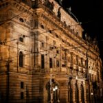 Prague National Theatre facade illuminated at night with golden lighting