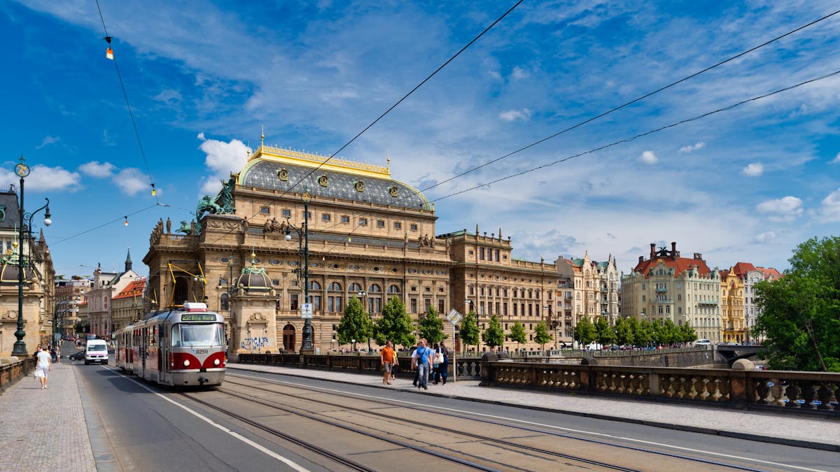 Beautiful view of Prague National Theatre with a tram on a sunny day