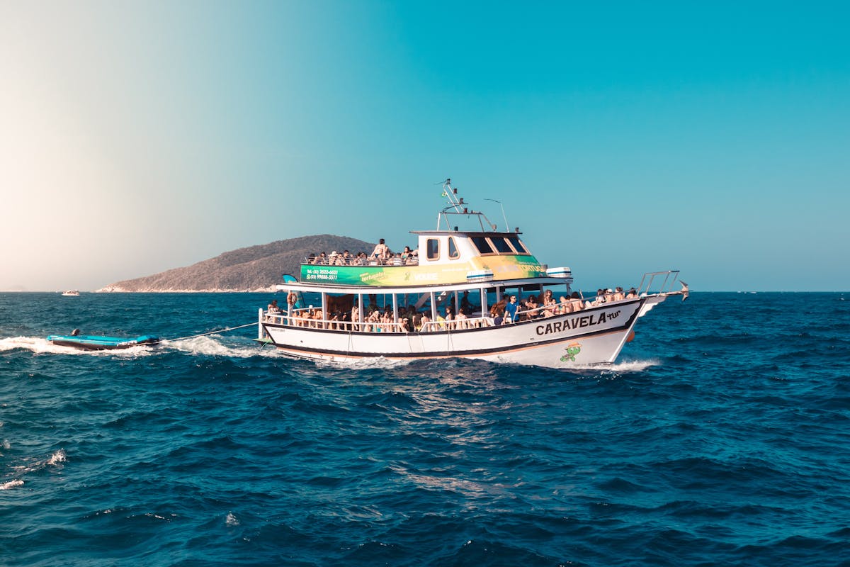 A boat tour with passengers enjoying a sunny day on the open ocean