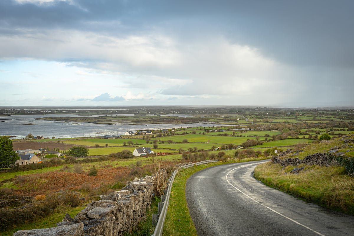 Burren landscape in County Clare with winding road through limestone karst terrain