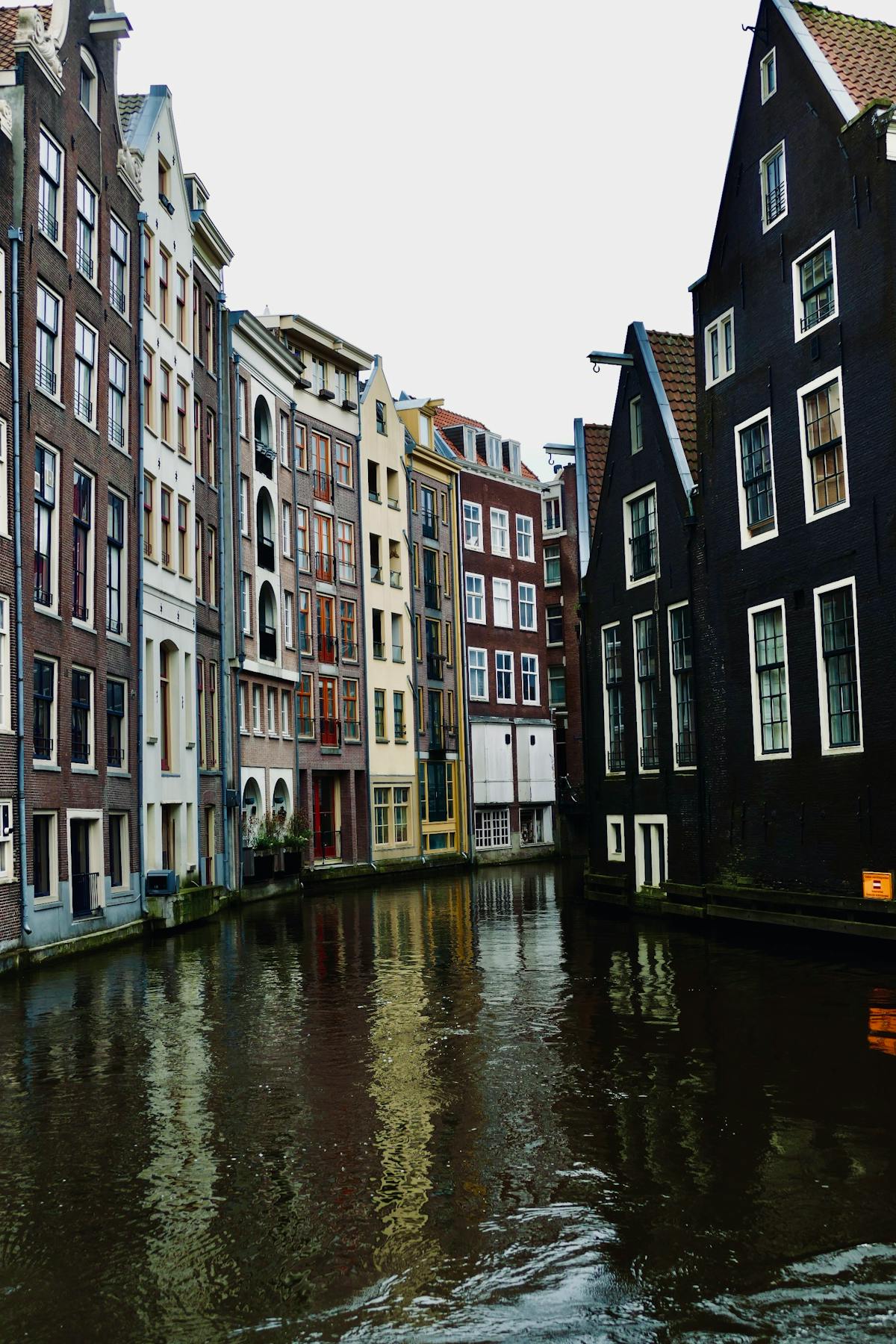 Traditional Amsterdam canal houses reflecting in calm canal water