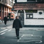 Candid street scene with people walking past textured wall in Dublin Ireland