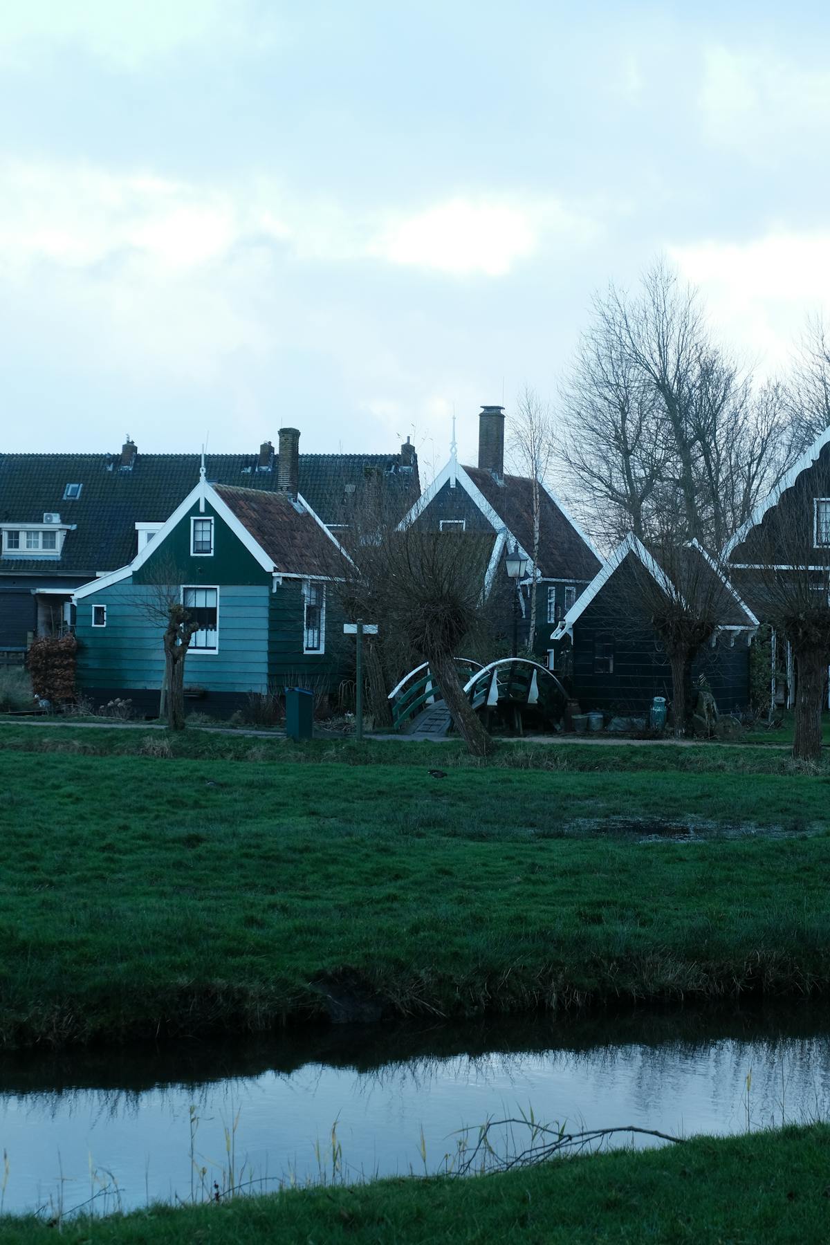 Picturesque view of traditional Dutch houses by a canal in Amsterdam