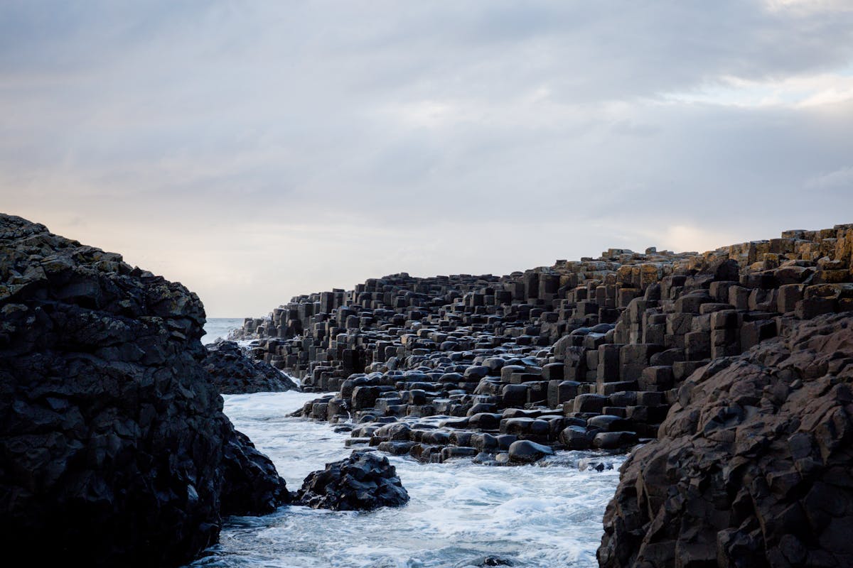 Giant Causeway with rocky formations and ocean waves in Northern Ireland