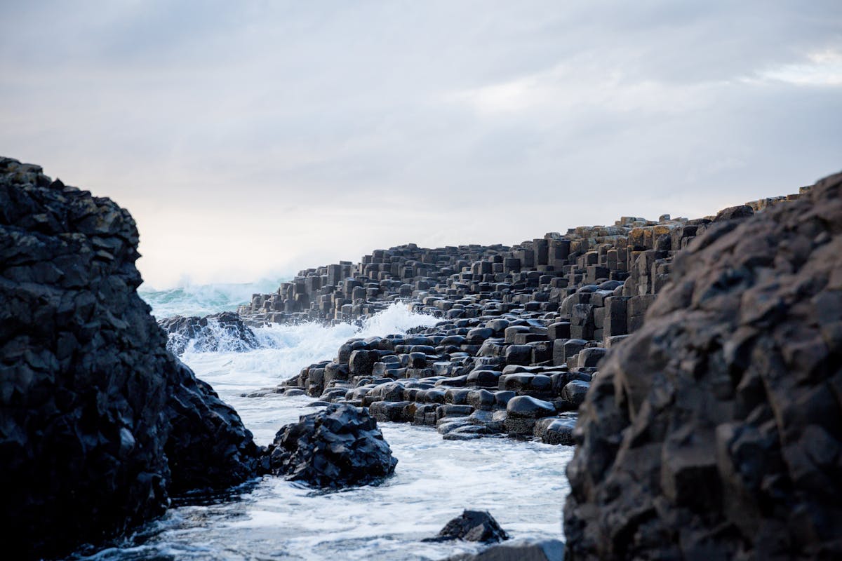 Ocean waves crashing against basalt columns at Giant Causeway