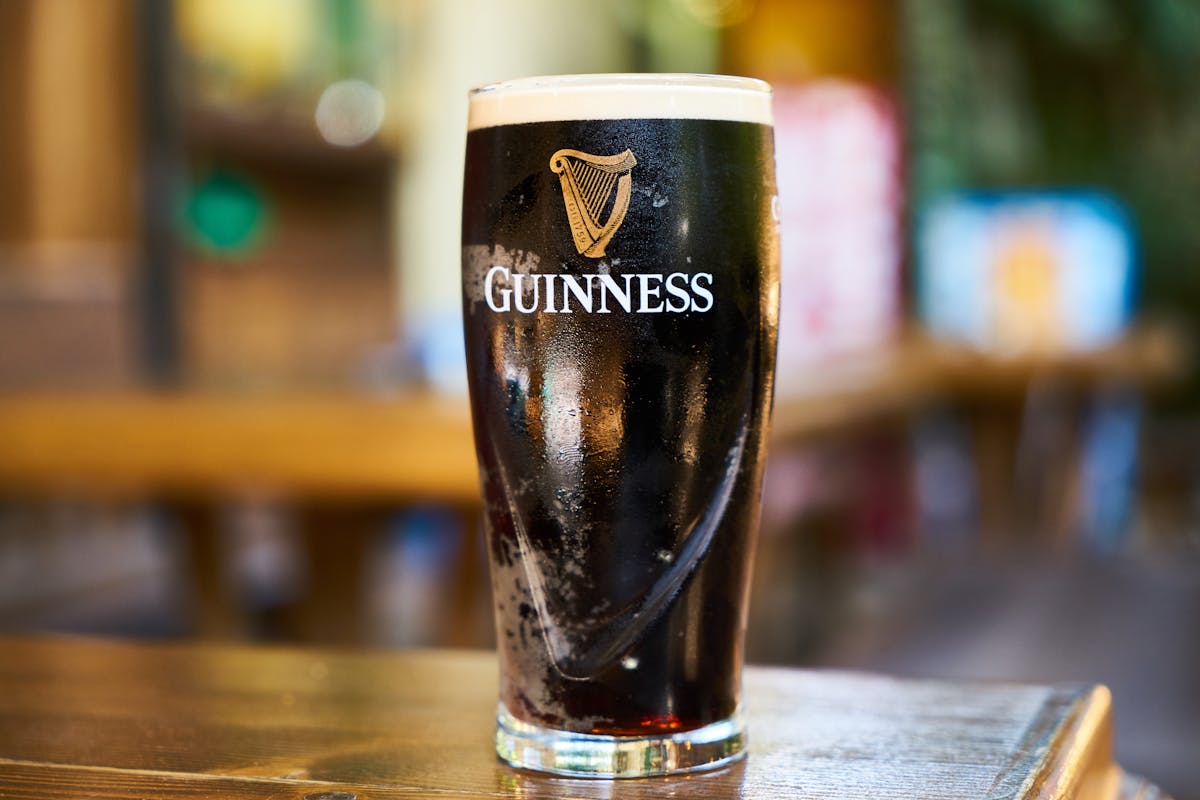 Close-up of a pint of Guinness stout beer on a wooden table