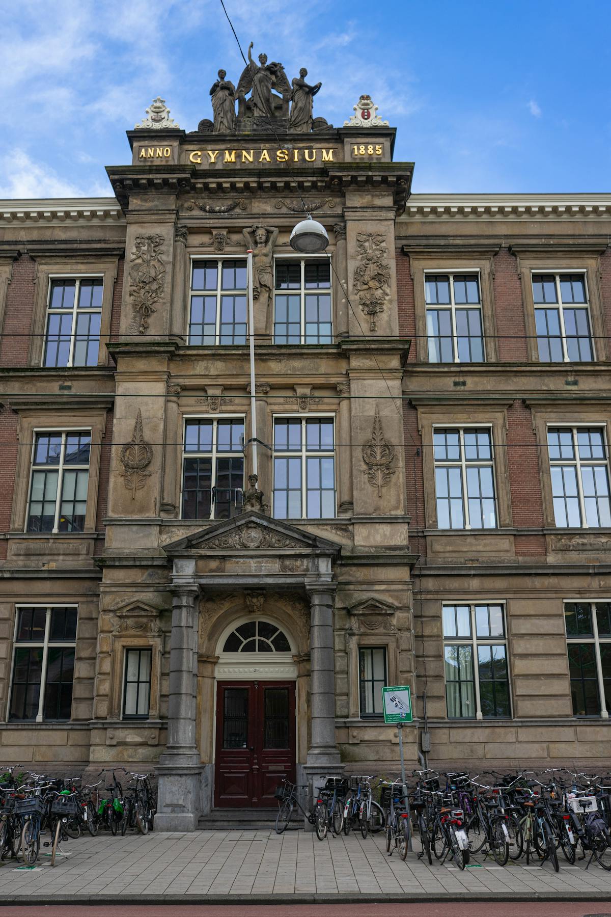 Front view of a historic building in Amsterdam with bicycles lined up outside