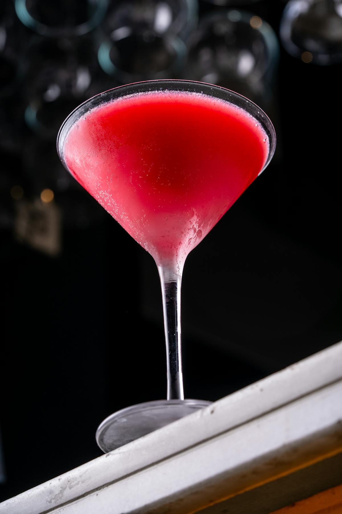 Bright and refreshing frozen red cocktail served in a classic martini glass