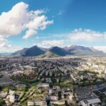 Panoramic view of Lisbon rooftops, river Tagus, and 25 de Abril Bridge from a hilltop viewpoint