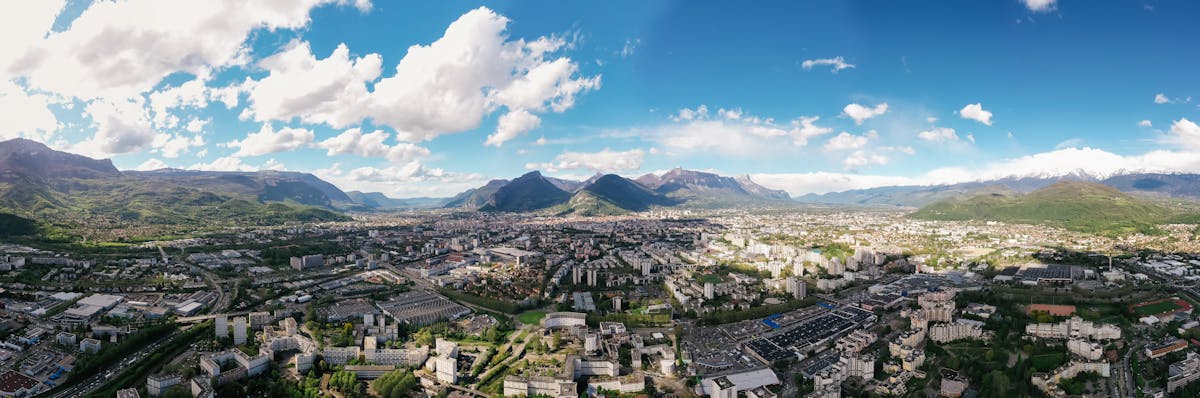 Panoramic view of Lisbon rooftops, river Tagus, and 25 de Abril Bridge from a hilltop viewpoint