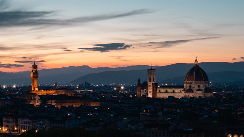 Florence skyline at sunset showing the Duomo dome and Palazzo Vecchio tower