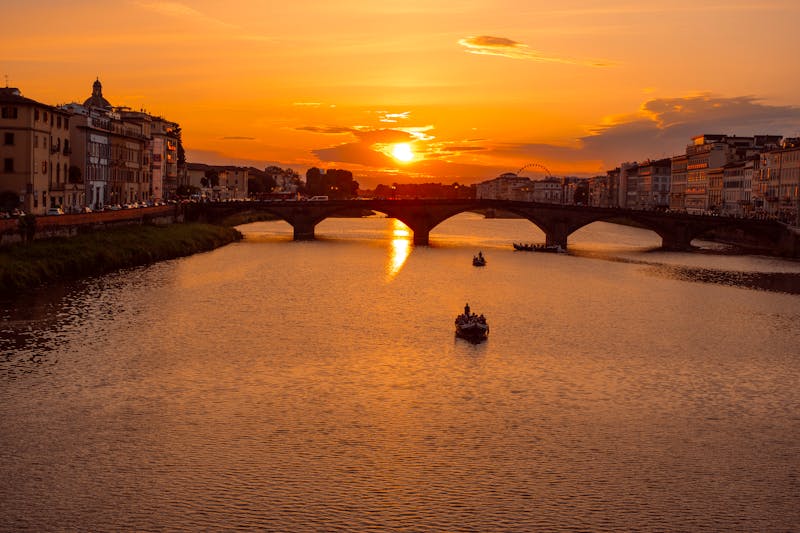 Golden sunset view of the Ponte Vecchio bridge over the Arno River in Florence Italy