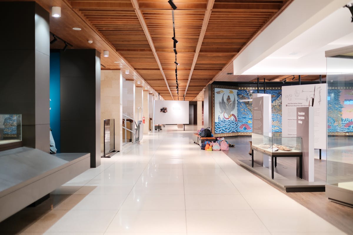 Bright museum hallway with exhibits and walkways featuring modern design