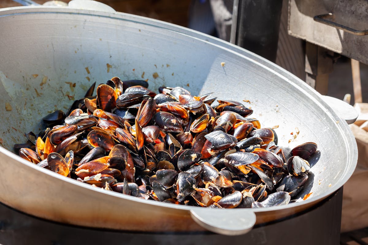 Close-up of freshly cooked mussels in a large wok