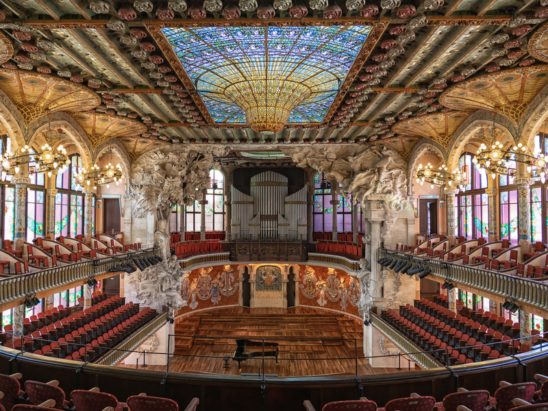 Ornate interior of the Palau de la Musica Catalana concert hall in Barcelona showing stained glass and sculptures