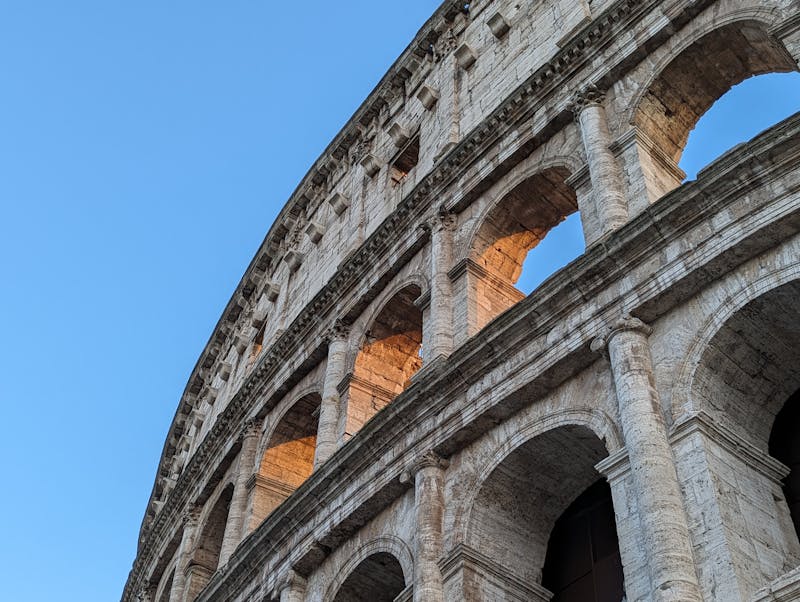 The Colosseum in Rome lit by golden sunset light