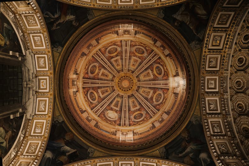 Looking up at the ornate dome ceiling inside St Peters Basilica in Vatican City