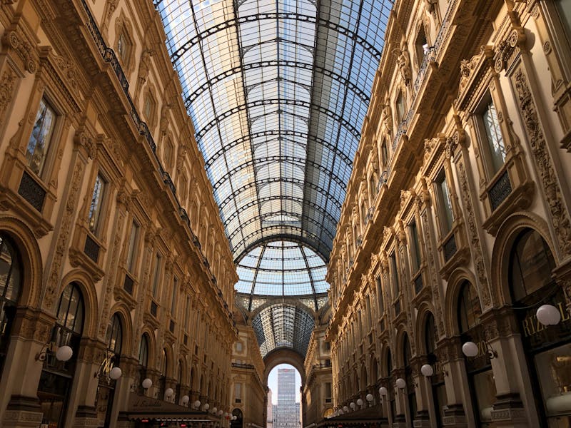 Interior view of Galleria Vittorio Emanuele II showing its arched glass ceiling and ornate architecture