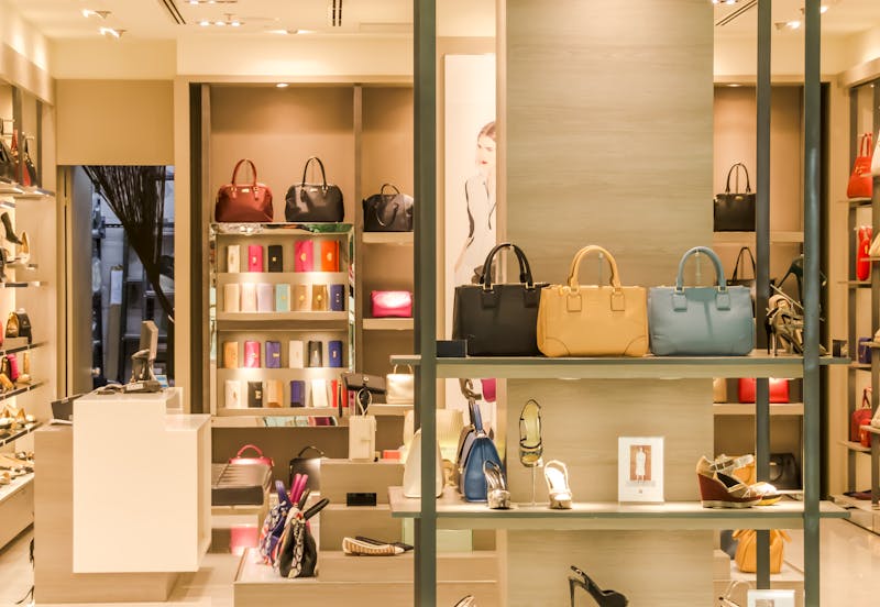 Boutique display with handbags and shoes arranged on shelves