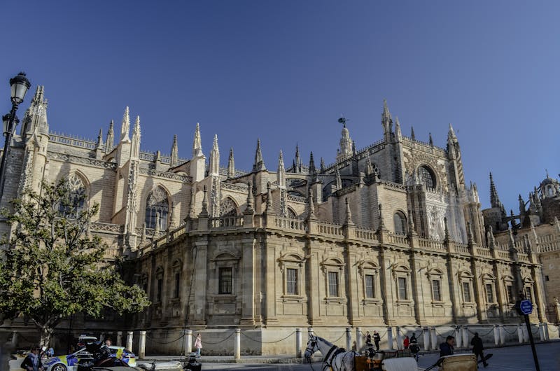 Seville Cathedral with a horse-drawn carriage in the historic center