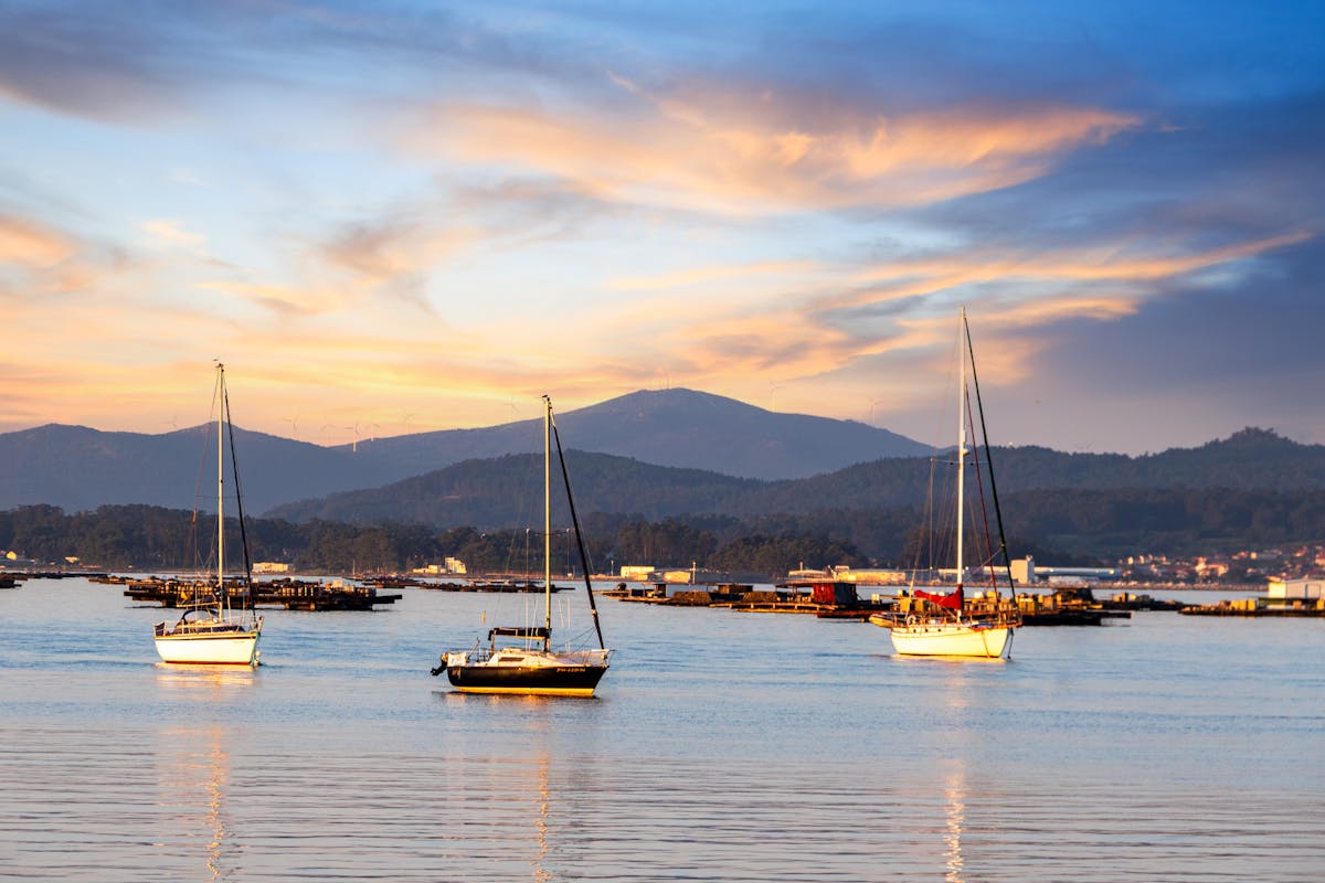 Scenic sunset view with sailboats at El Grove Spain harbor