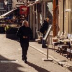 Sunlit Amsterdam street with charming cafes and local shops