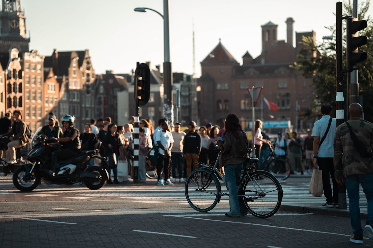 Vibrant day in Amsterdam with cyclists and pedestrians by historic buildings