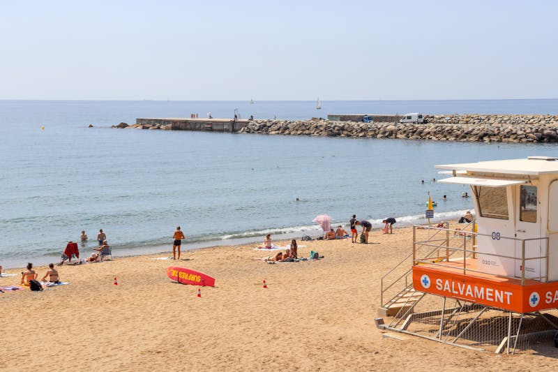 Barceloneta beach scene with lifeguard tower and sunbathers
