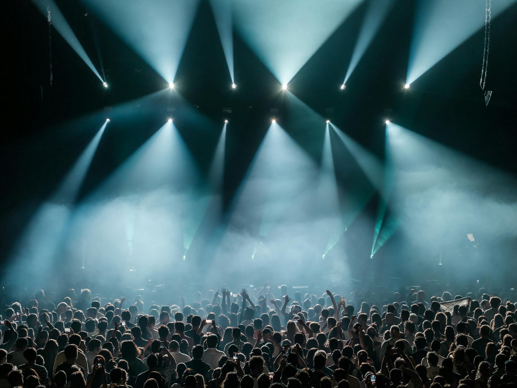 Concert scene with a large crowd and vibrant stage lighting