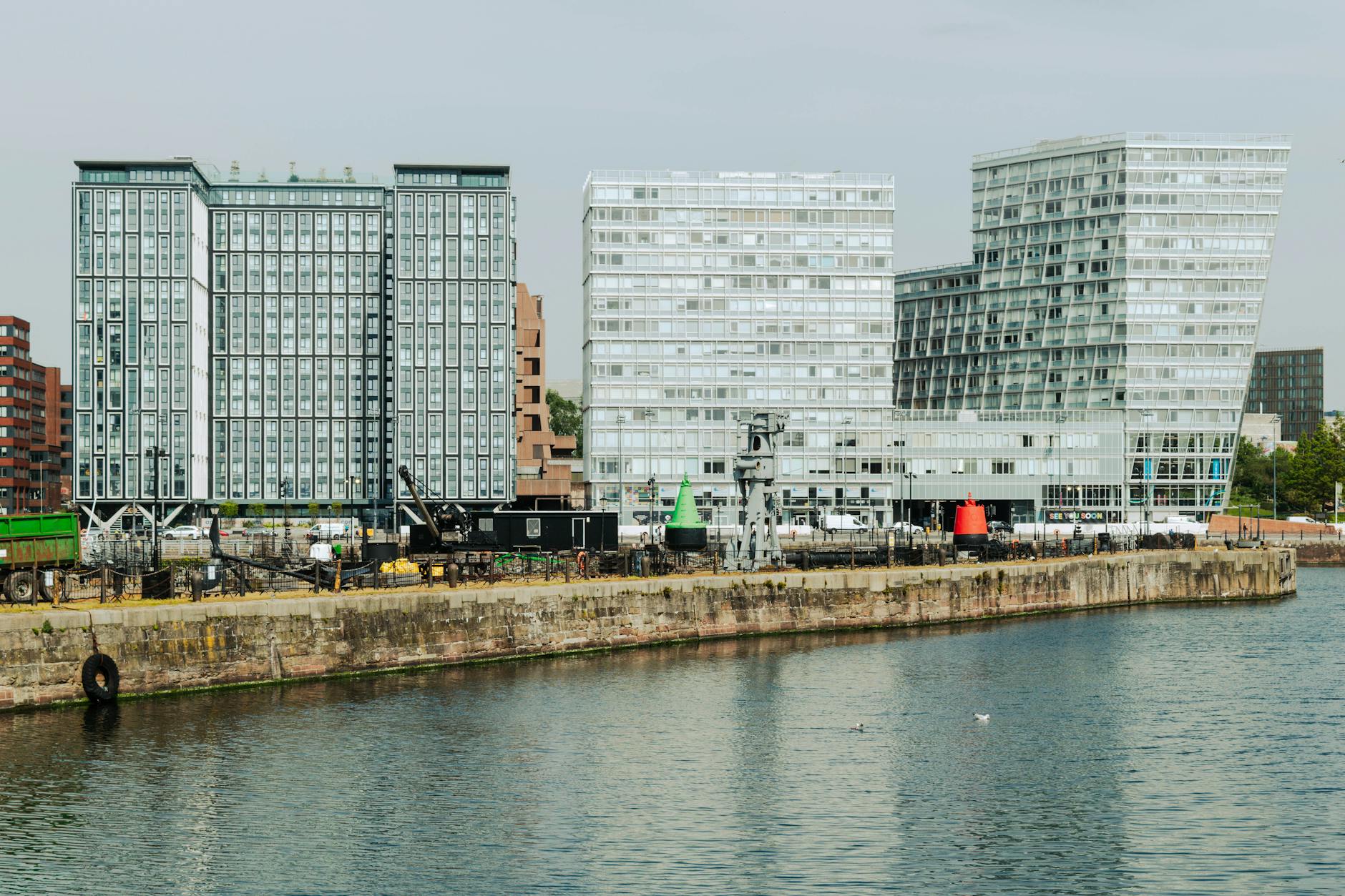 Contemporary buildings reflecting on water at Liverpool waterfront