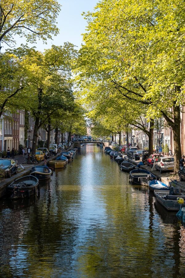 Classic blue bicycle parked on a canal bridge in Amsterdam
