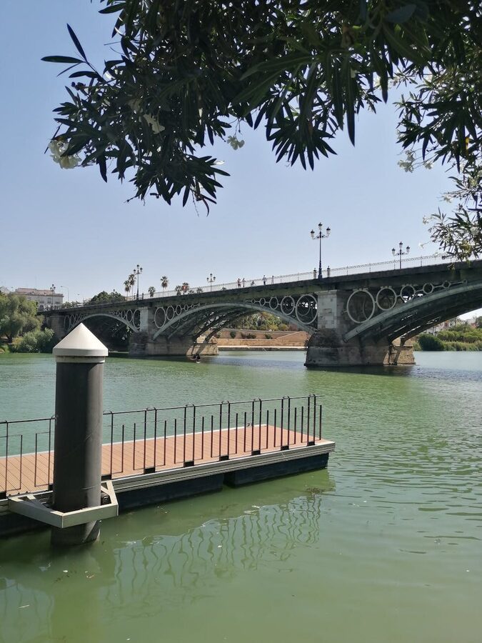A sightseeing cruise boat sailing on the Guadalquivir River in Seville