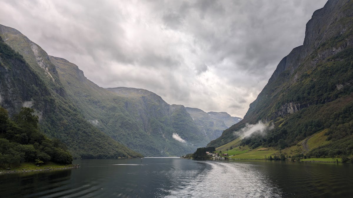 Dramatic view of a fjord near Bergen Norway under cloudy skies with steep mountain walls
