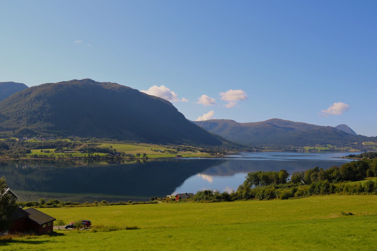 Norwegian fjord landscape with calm water reflections during summer near Bergen