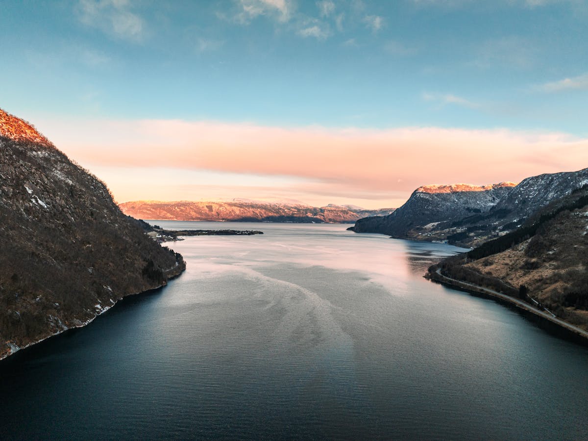 Norwegian fjord during winter with snow-covered mountains and calm waters